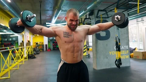 Bald bodybuilder exercising in the gym. ... | Stock Video | Pond5