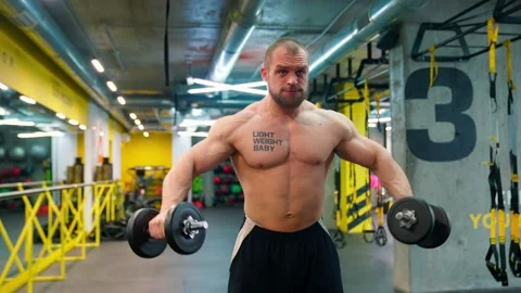 Bald bodybuilder exercising in the gym. ... | Stock Video | Pond5