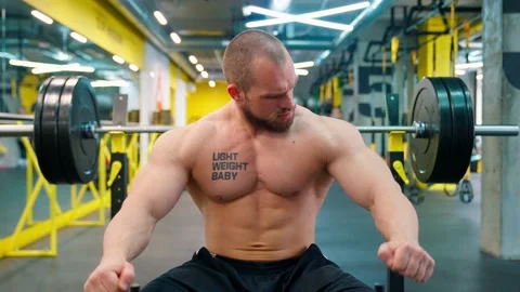 Bald bodybuilder exercising in the gym. ... | Stock Video | Pond5