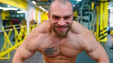 Bald bodybuilder exercising in the gym. ... | Stock Video | Pond5