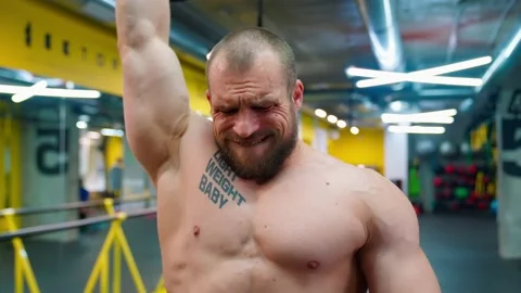 Bald bodybuilder exercising in the gym. ... | Stock Video | Pond5