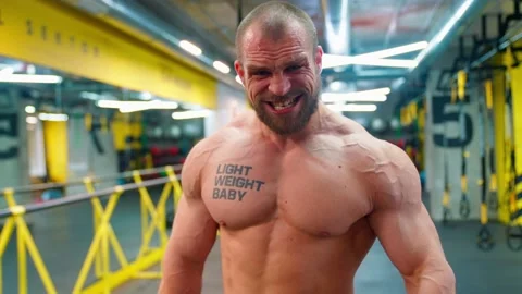 Bald bodybuilder exercising in the gym. ... | Stock Video | Pond5