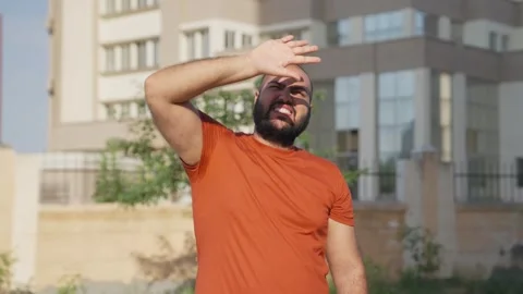 Bald indian Man Covering Face from Sun w... | Stock Video | Pond5