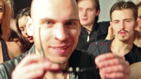 Bald man in black jacket dancing on a pa... | Stock Video | Pond5
