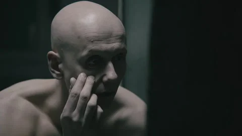 A Bald prisoner in the prison looking at... | Stock Video | Pond5