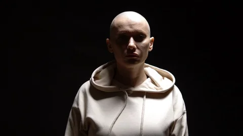 a bald woman looks sadly into the camera... | Stock Video | Pond5