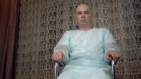 A bald young man with cancer looks at th... | Stock Video | Pond5