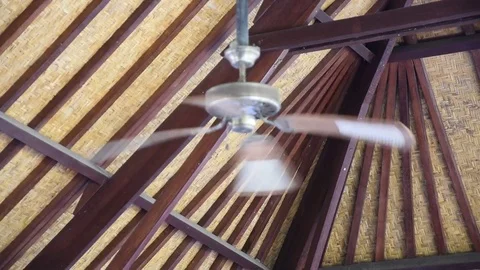 Bali hut fan spinning with focussed back... | Stock Video | Pond5