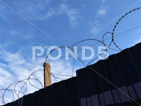 Barbed twisted wire metal fence close view photo Stock Image #167538736