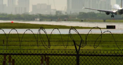 Barbed Wire Airport Fence with Jet Touch... | Stock Video | Pond5