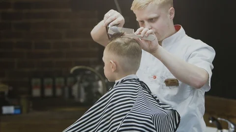 Barbershop. Stylish little boy makes a h... | Stock Video | Pond5
