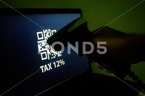 A barcode scanner is scanning a QR code displayed on a screen with the ...