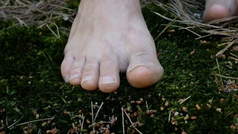 Bare feet on the moss. The girl touches ... | Stock Video | Pond5