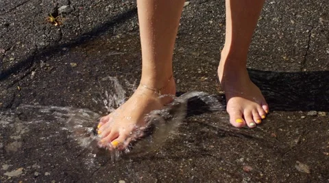 Barefoot female dancing in puddle | Stock Video | Pond5