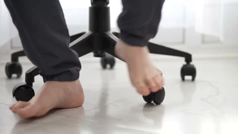 Barefoot men's feet on an office chair w... | Stock Video | Pond5