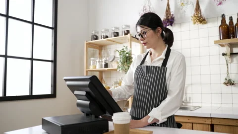 barista in apron touching screen | Stock Video | Pond5