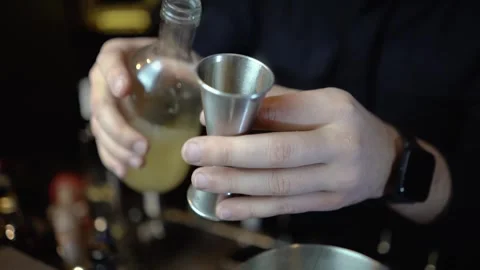The bartender behind the bar makes an al... | Stock Video | Pond5