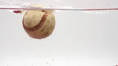 Baseball falling and spinning into water... | Stock Video | Pond5