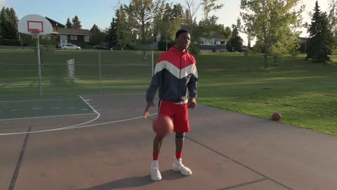 Basketball player bouncing ball on court | Stock Video | Pond5