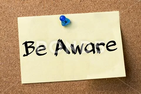 Be Aware - adhesive label pinned on bulletin board Stock Photo #72439560