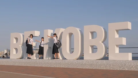 Be Kobe sign with schoolgirls making sel... | Stock Video | Pond5