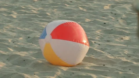 A beach ball sits on the beach after a l... | Stock Video | Pond5