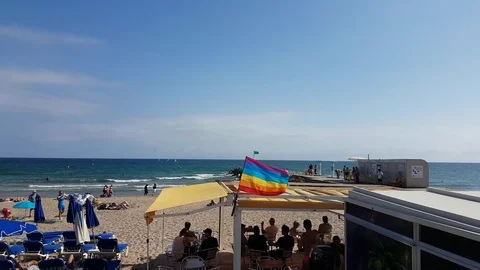 Beach bar people rainbow pride flag blow... | Stock Video | Pond5