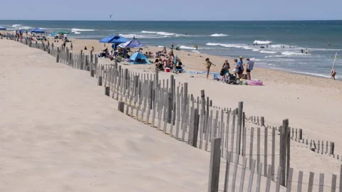 Beach goers at Nags Head Beach on the ou... | Stock Video | Pond5