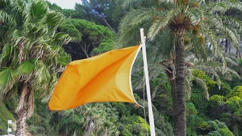 beach orange level of warning flag on fl... | Stock Video | Pond5