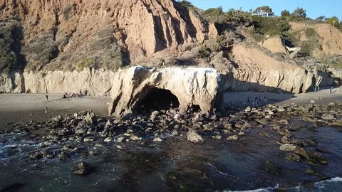 Beach with rocks, caves and cliffs aeria... | Stock Video | Pond5
