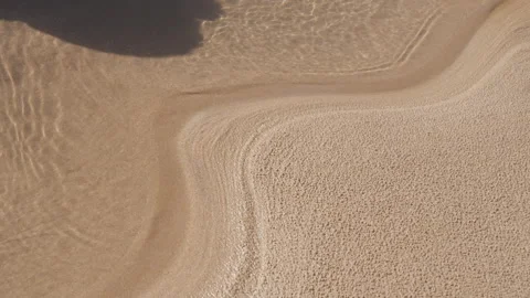 Beach sand with clean moving water. | Stock Video | Pond5