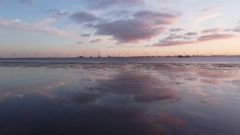 beach scene with reflections of the sky ... | Stock Video | Pond5