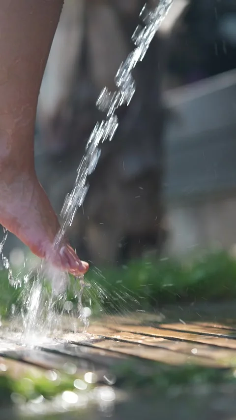 With the beach shower at hand, the girl ... | Stock Video | Pond5