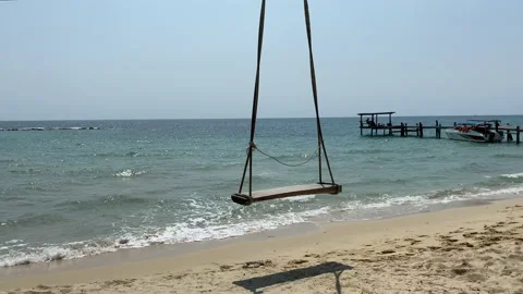 Beach swing and watching ocean waves. | Stock Video | Pond5