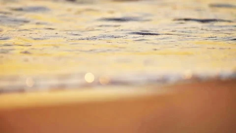 beach wave splashing macro in sunset | Stock Video | Pond5