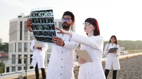 Bearded doctor in white lab coat present... | Stock Video | Pond5