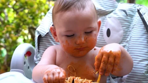 Beautiful baby enjoying making a mess wh... | Stock Video | Pond5