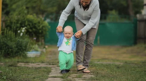 Beautiful baby takes its first steps wit... | Stock Video | Pond5
