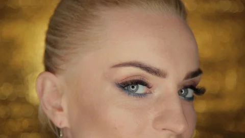 Beautiful beauty model posing on a gold ... | Stock Video | Pond5