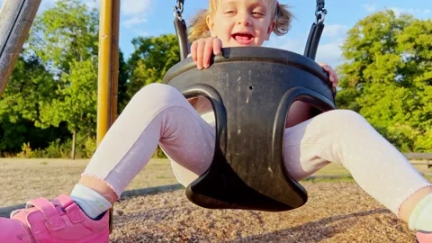 Beautiful blond little girl ride sitting... | Stock Video | Pond5