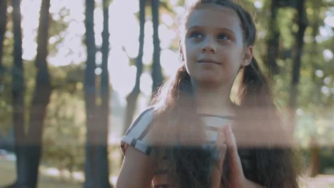 Beautiful curly little girl is happy pra... | Stock Video | Pond5