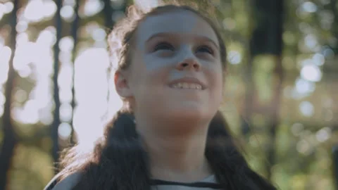 Beautiful curly little girl is happy pra... | Stock Video | Pond5