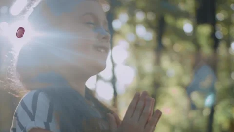 Beautiful curly little girl is happy pra... | Stock Video | Pond5