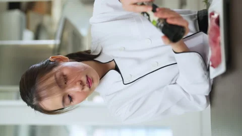 Beautiful female chef cooking at kitchen... | Stock Video | Pond5