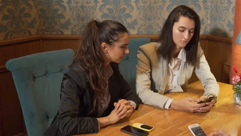 Beautiful female friends sit in cosy caf... | Stock Video | Pond5