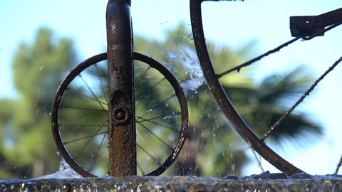 Beautiful fountain and spinning bicycle ... | Stock Video | Pond5
