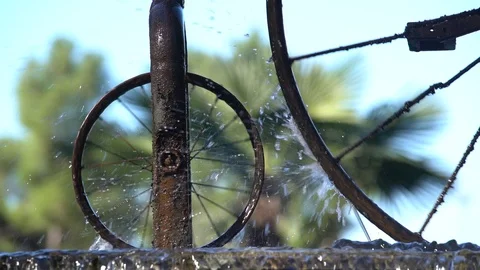 Beautiful fountain and spinning bicycle ... | Stock Video | Pond5
