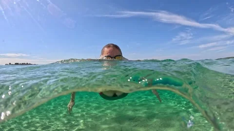 Beautiful girl swimmer swims in the sea ... | Stock Video | Pond5