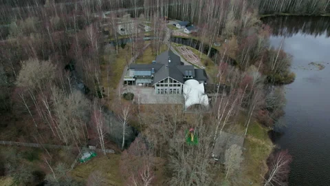 Beautiful house, trees and lake | Stock Video | Pond5