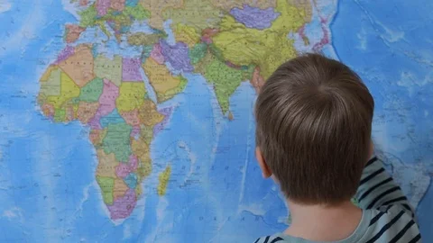 Beautiful kid measure distance on world ... | Stock Video | Pond5